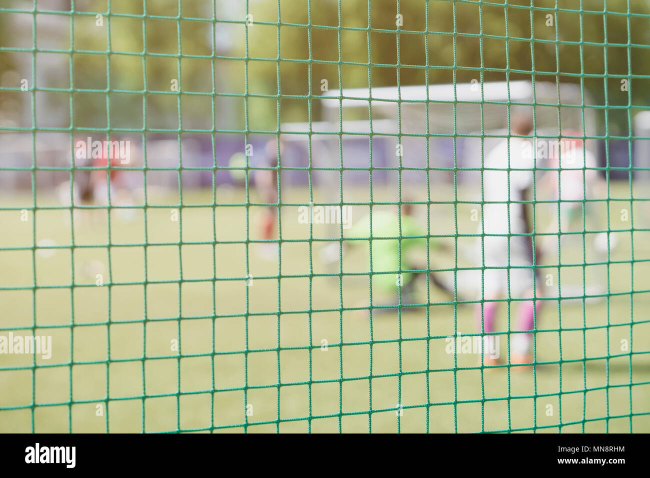 Football, soccer field, soccer gate, view from soccer goal net, blurred ...