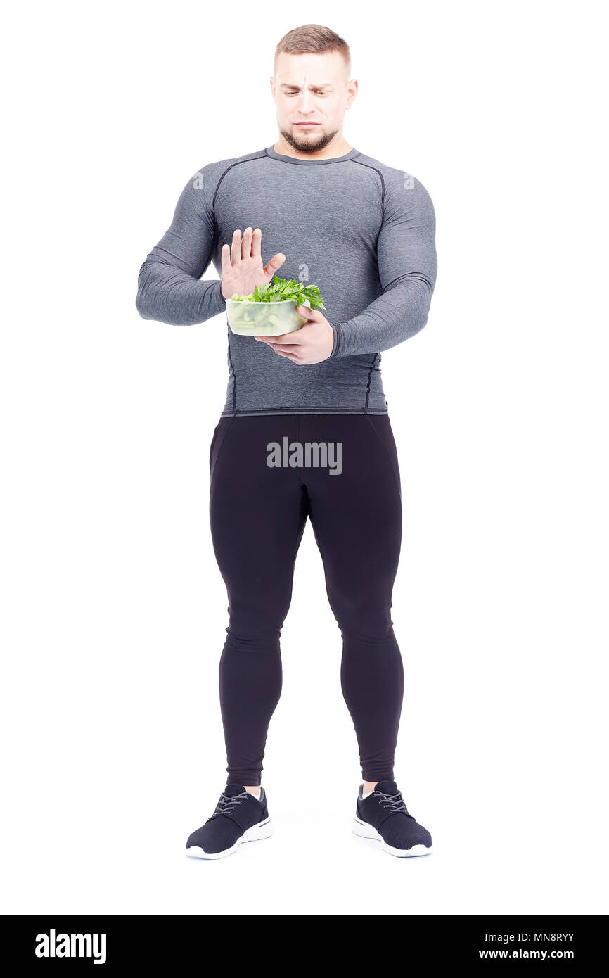 Full-length portrait of well-muscled male athlete holding lunch box ...