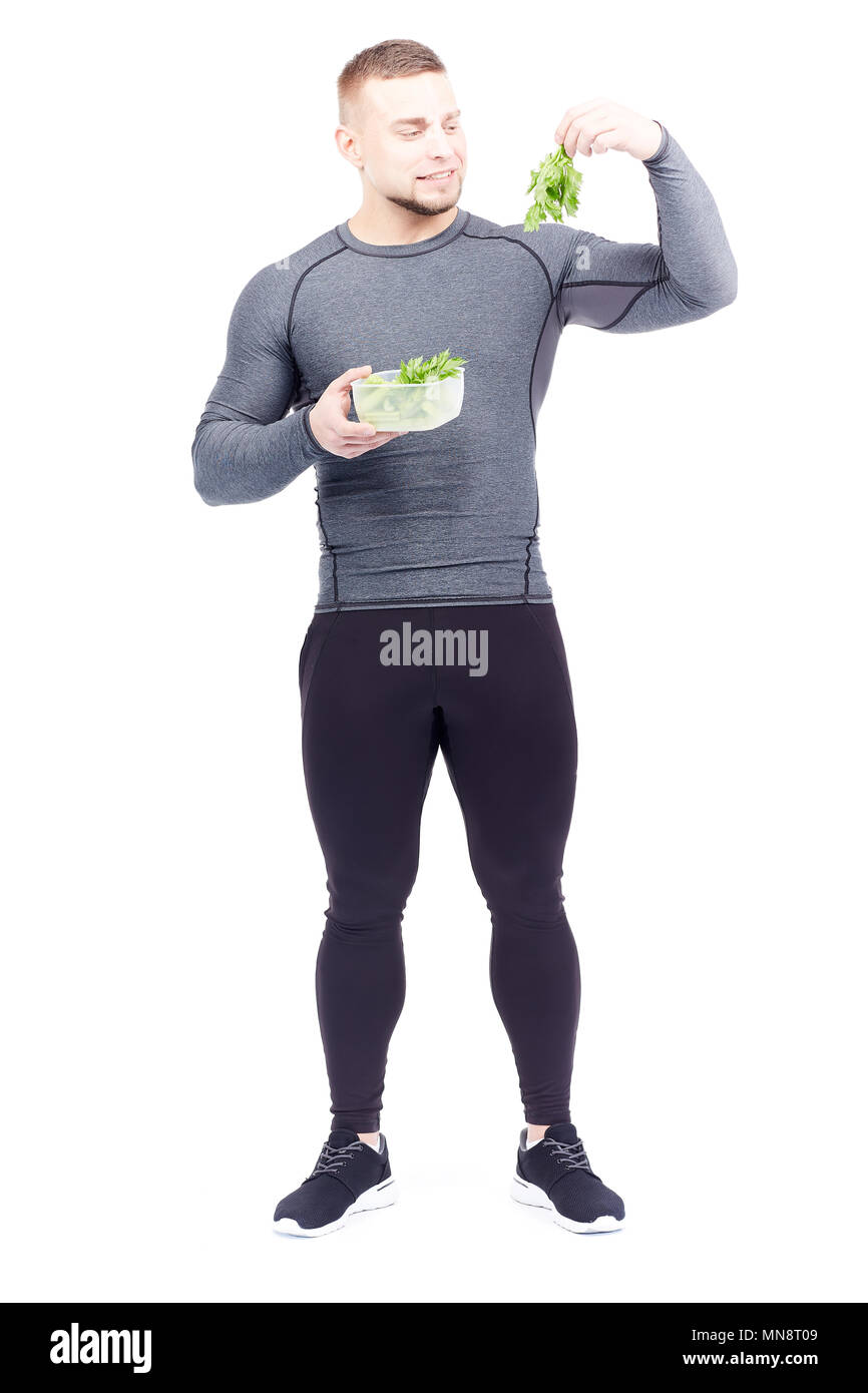 Full-length portrait of well-muscled male athlete holding lunch box ...