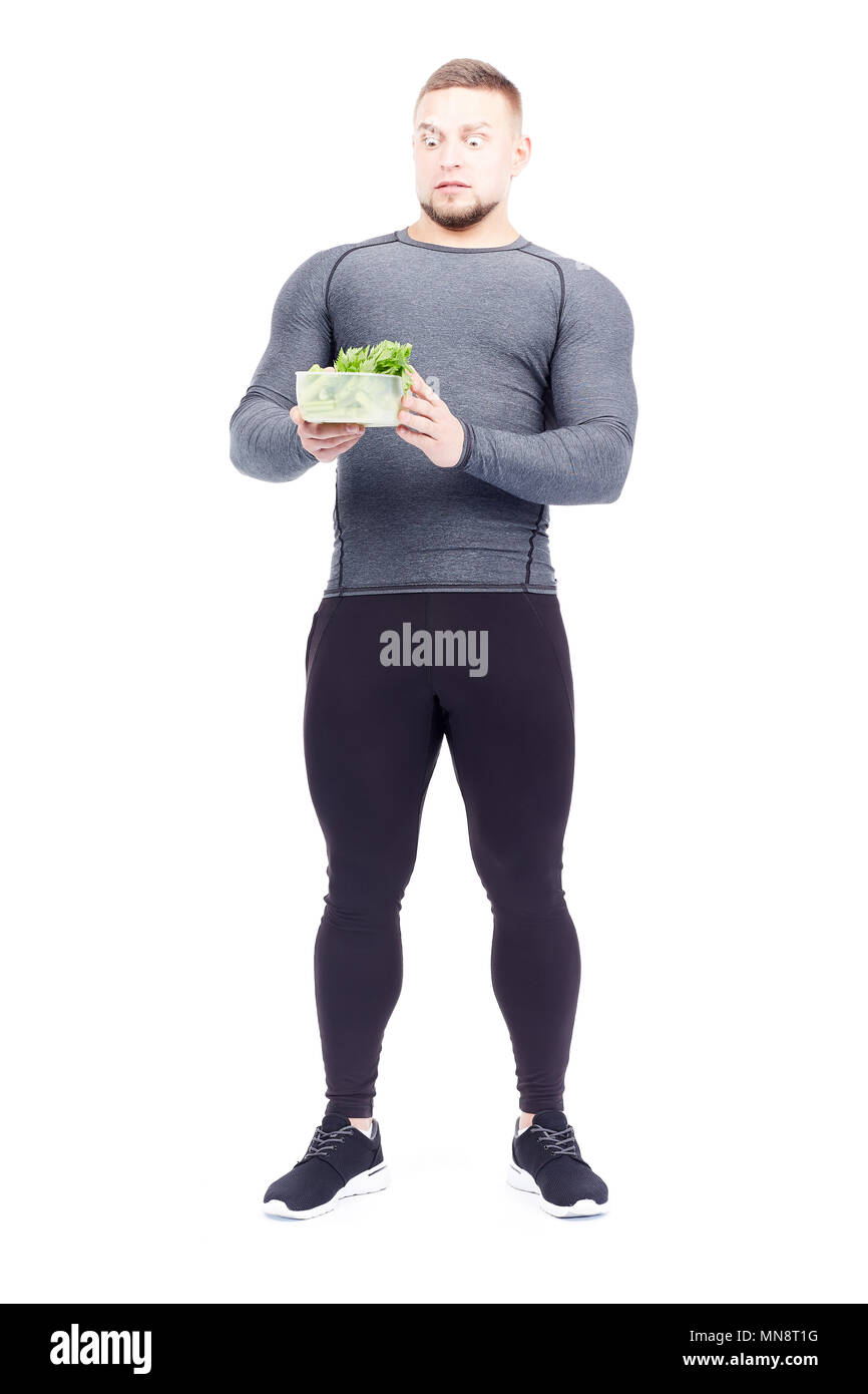 Full-length portrait of well-muscled male athlete holding lunch box ...