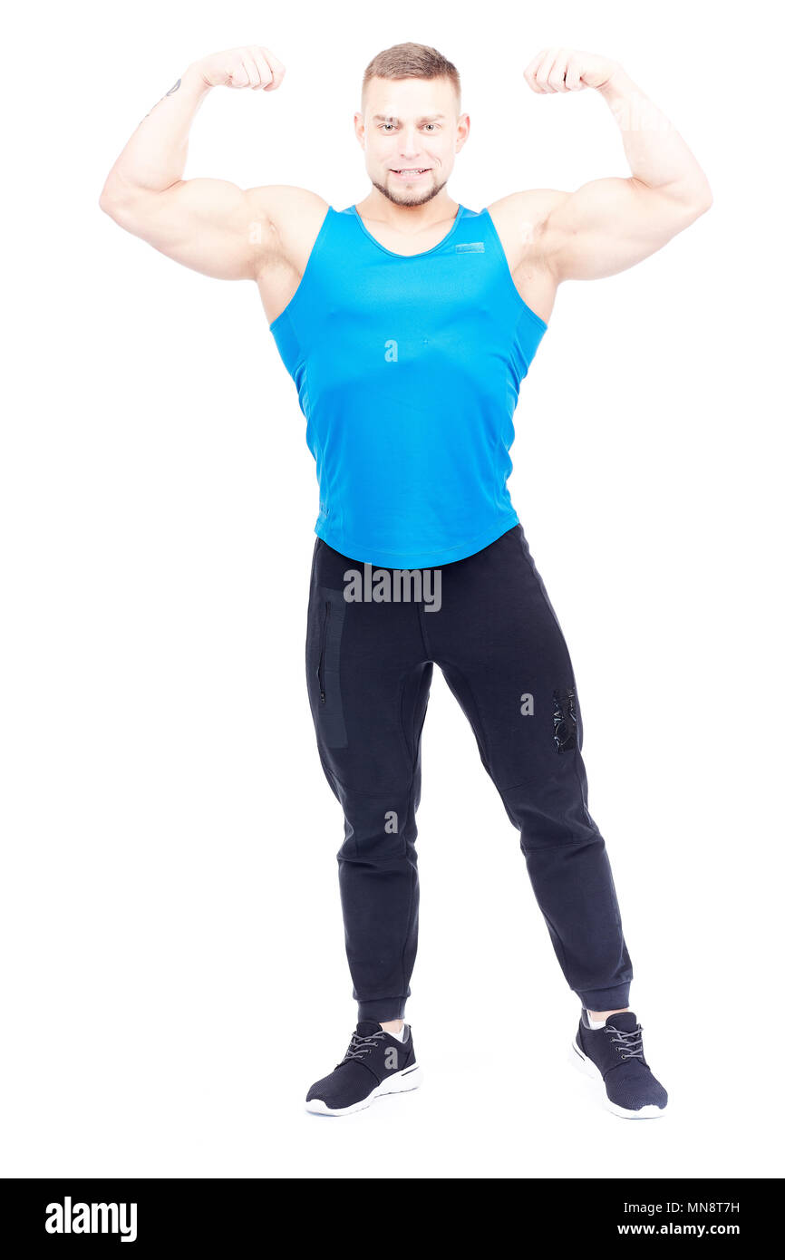 Portrait of strong athletic man in sports clothes posing on white ...