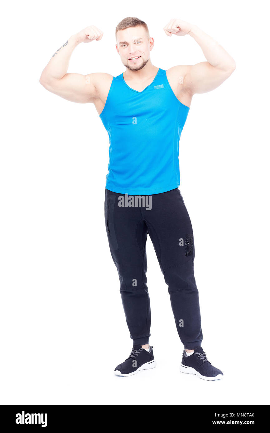 Portrait of strong athletic man in sports clothes posing on white ...