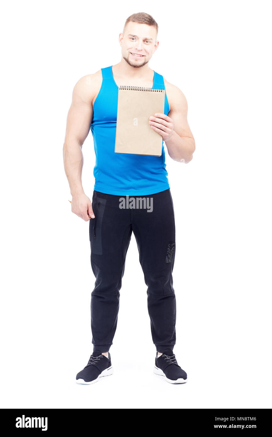 Portrait of sports trainer showing blank sheet of notebook paper at ...