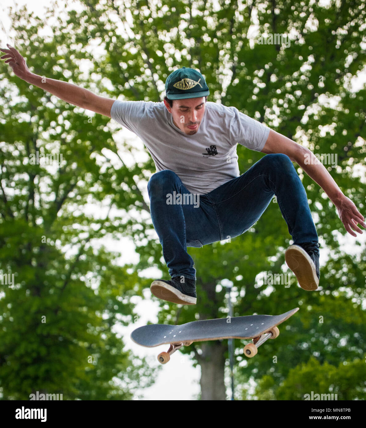 A young white man performing a skateboard trick Stock Photo - Alamy