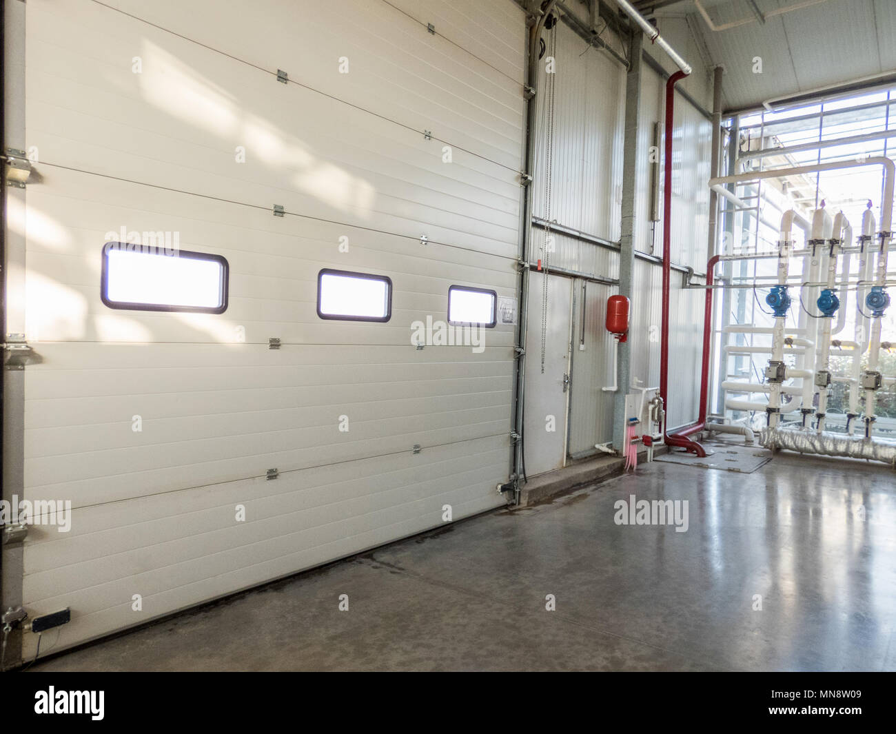 large closed gate with windows in the factory. pipes and motor Stock ...
