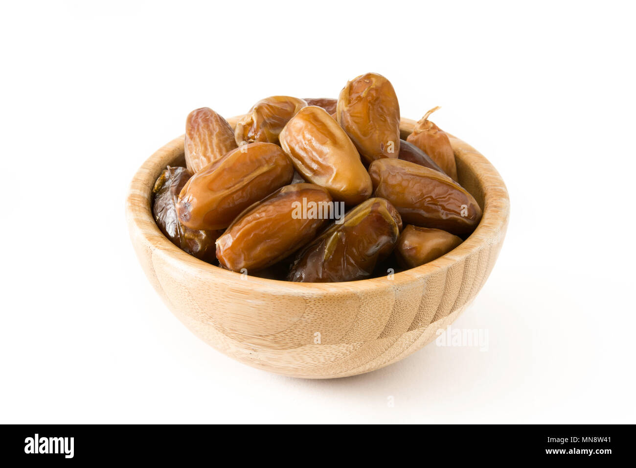 Dates food in wooden bowl isolated on white background Stock Photo - Alamy