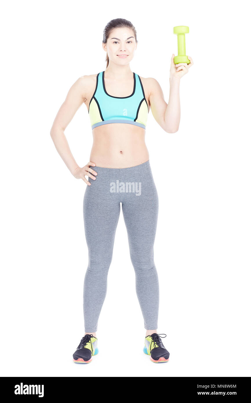 Portrait of attractive female gym goer exercising with dumbbells on ...