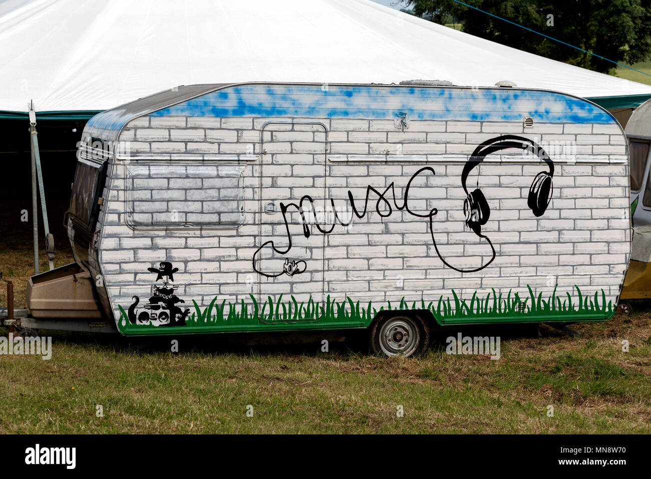 A caravan painted with a brick work design and the word "music ...