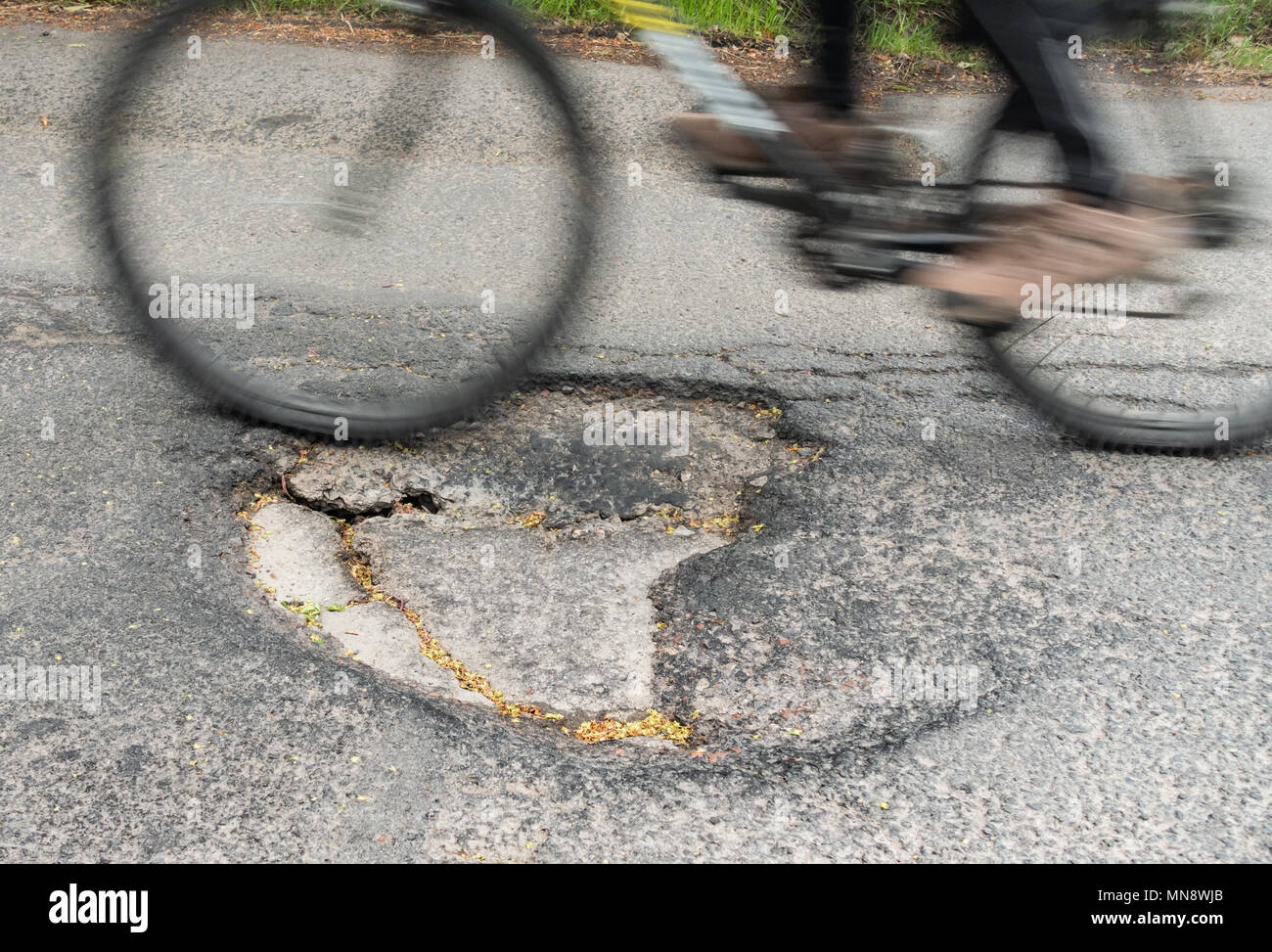 Potholes cyclist hi-res stock photography and images - Alamy