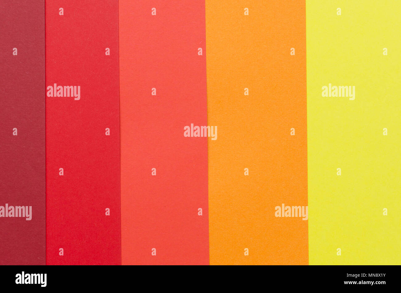 warm-colored construction paper sheets arranged vertically Stock Photo ...