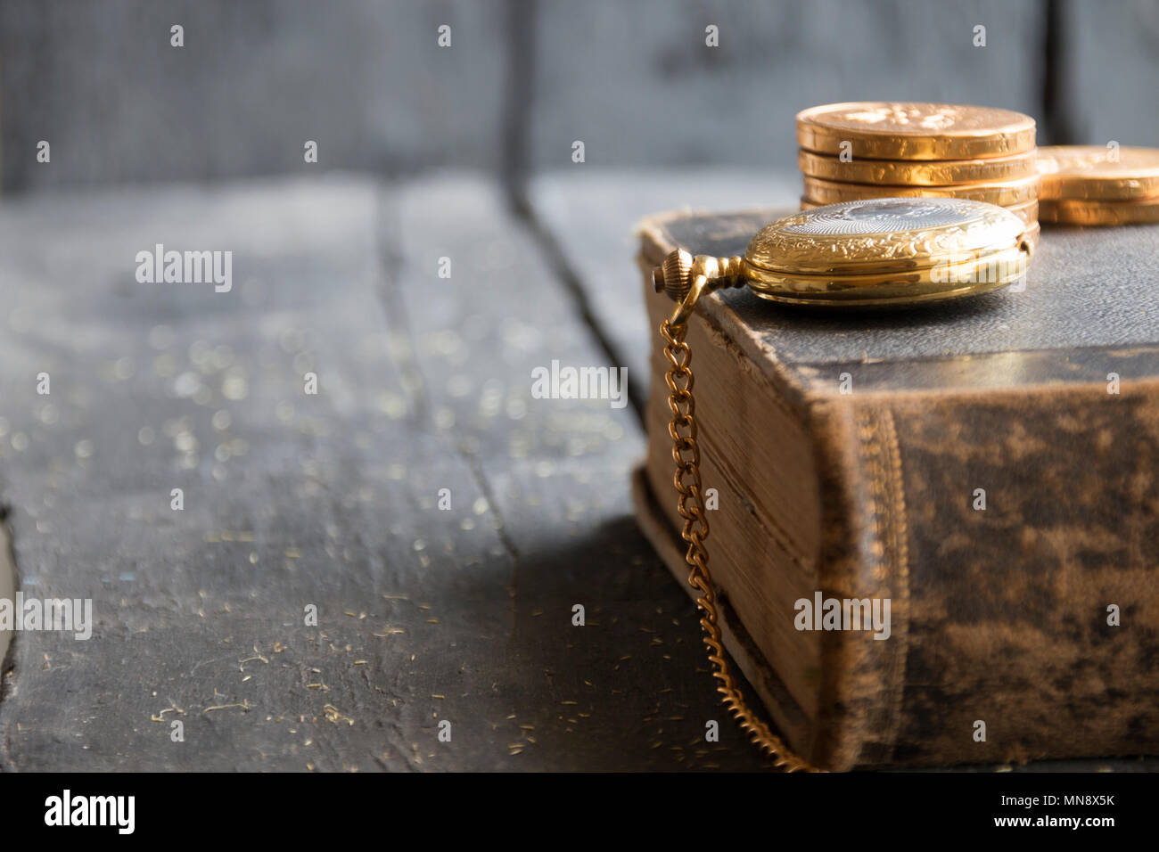 business background with gold pocket watch, book and coins Stock Photo ...