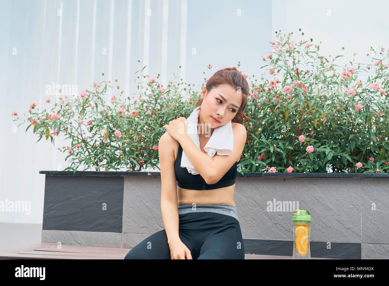 young beautiful and fit sport woman after running workout sitting on ...