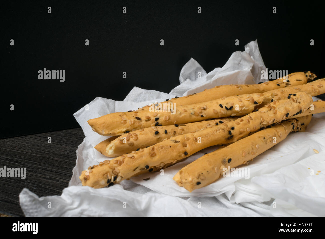 homemade snack, baked sticks with sesame and black cumin on the white ...