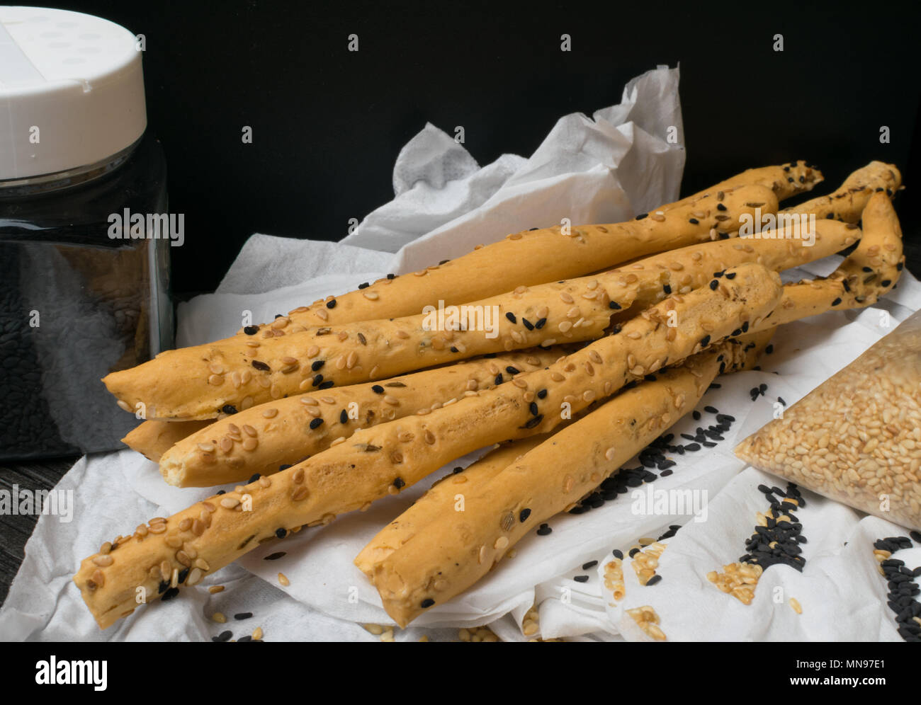 homemade snack, baked sticks with sesame and black cumin on the white ...