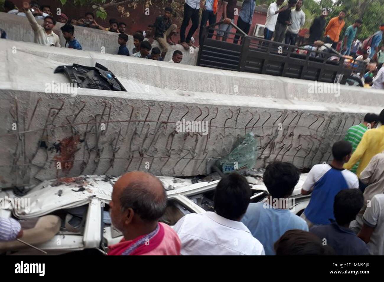 Varanasi, India. 15th May, 2018. People gather near collapsed under ...