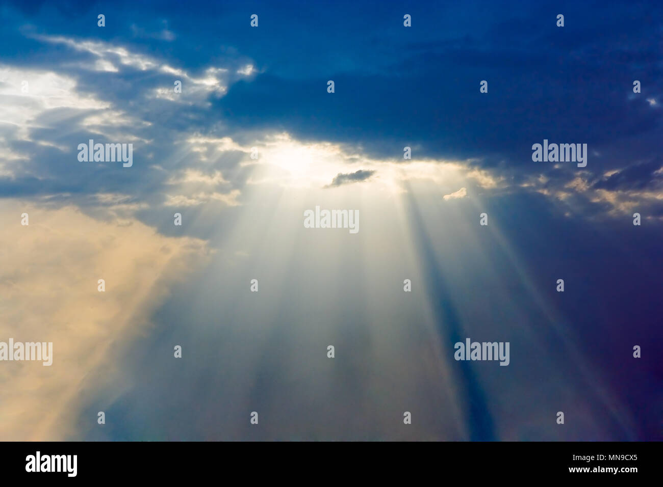Fantastic sun rays are striking through the clouds like an explosion ...