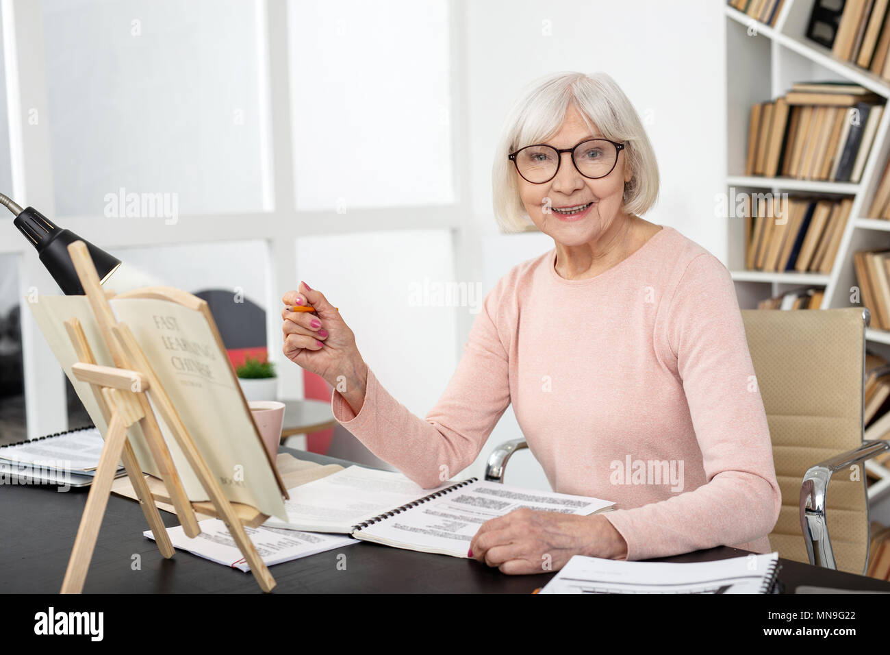 Positive senior woman studying subject Stock Photo - Alamy