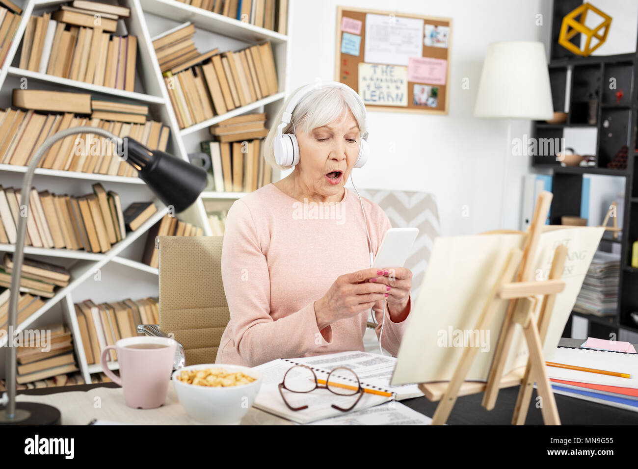 Beautiful mature woman repeating after audio Stock Photo - Alamy