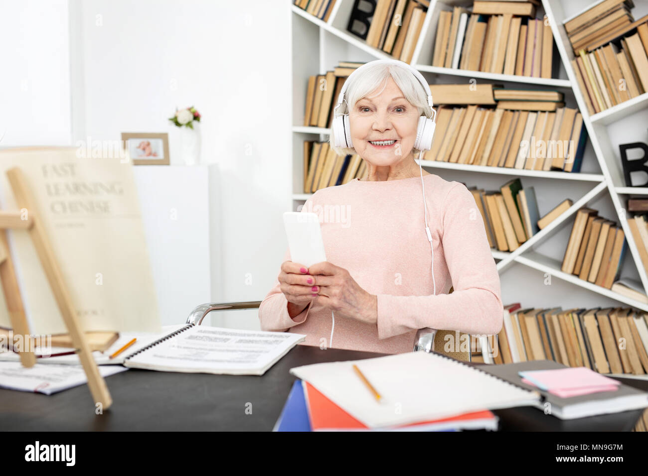 Positive mature woman listening speech Stock Photo - Alamy