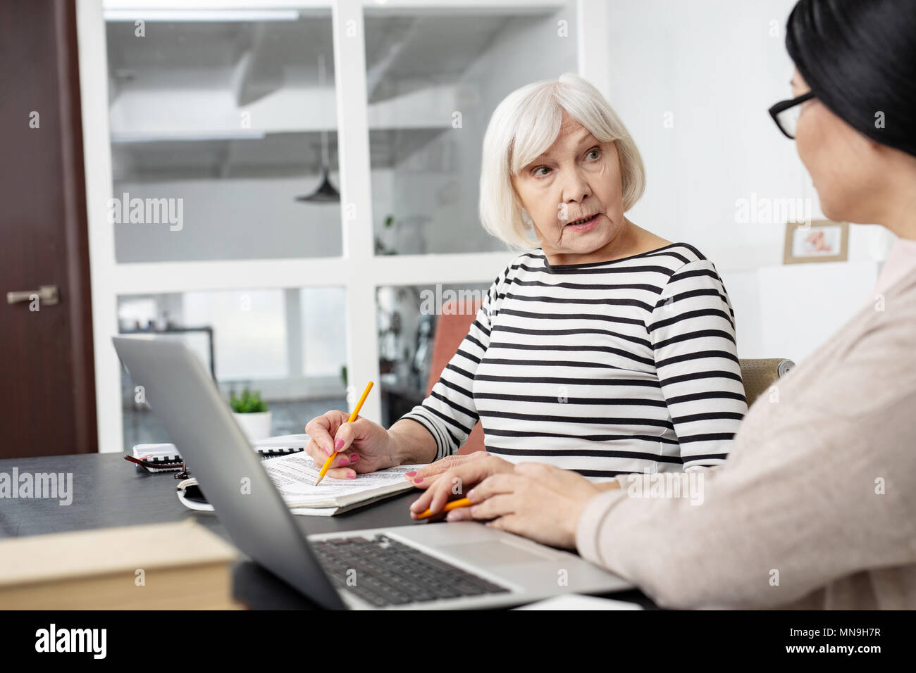 Mature woman listening surprised hi-res stock photography and images ...