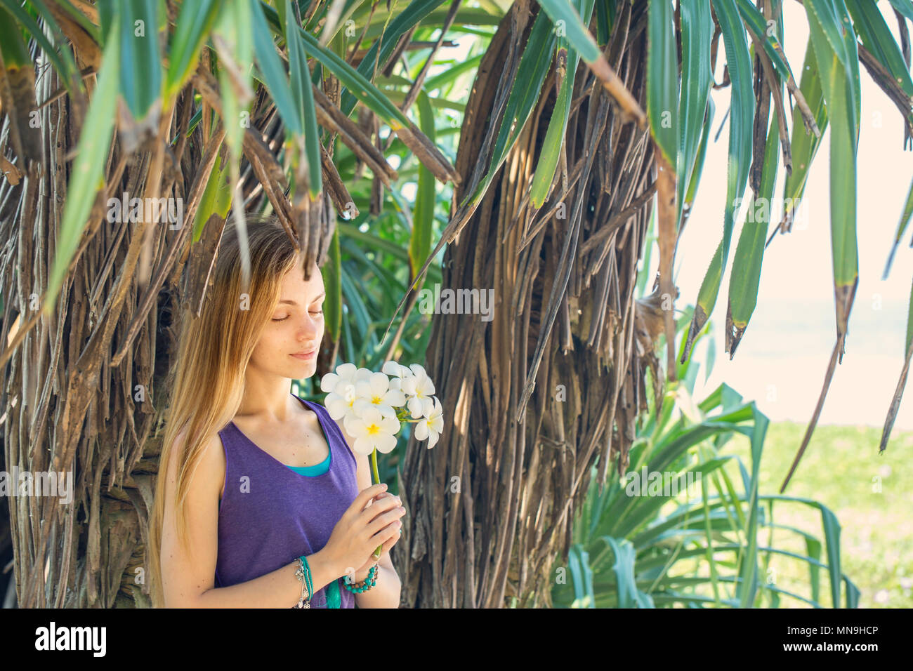 Young woman under the palm trees Stock Photo - Alamy
