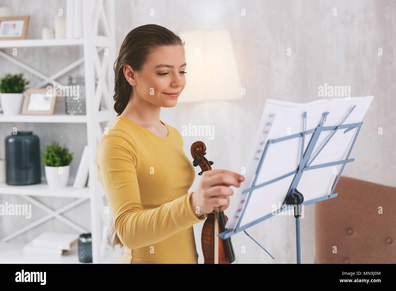 Pleased girl choosing favorite work Stock Photo - Alamy