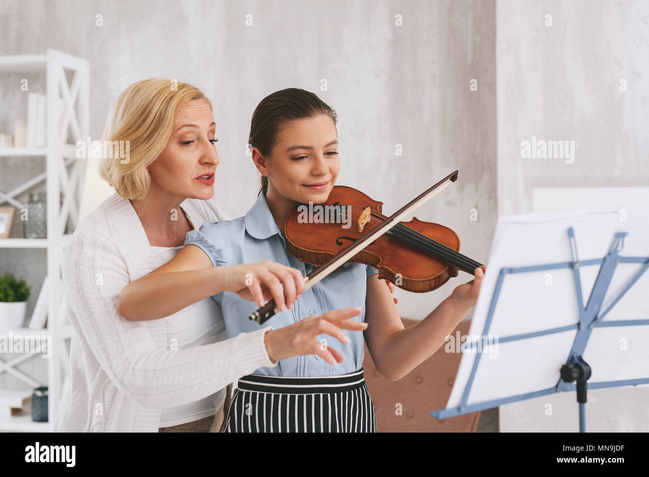 Positive delighted musician playing melody Stock Photo - Alamy