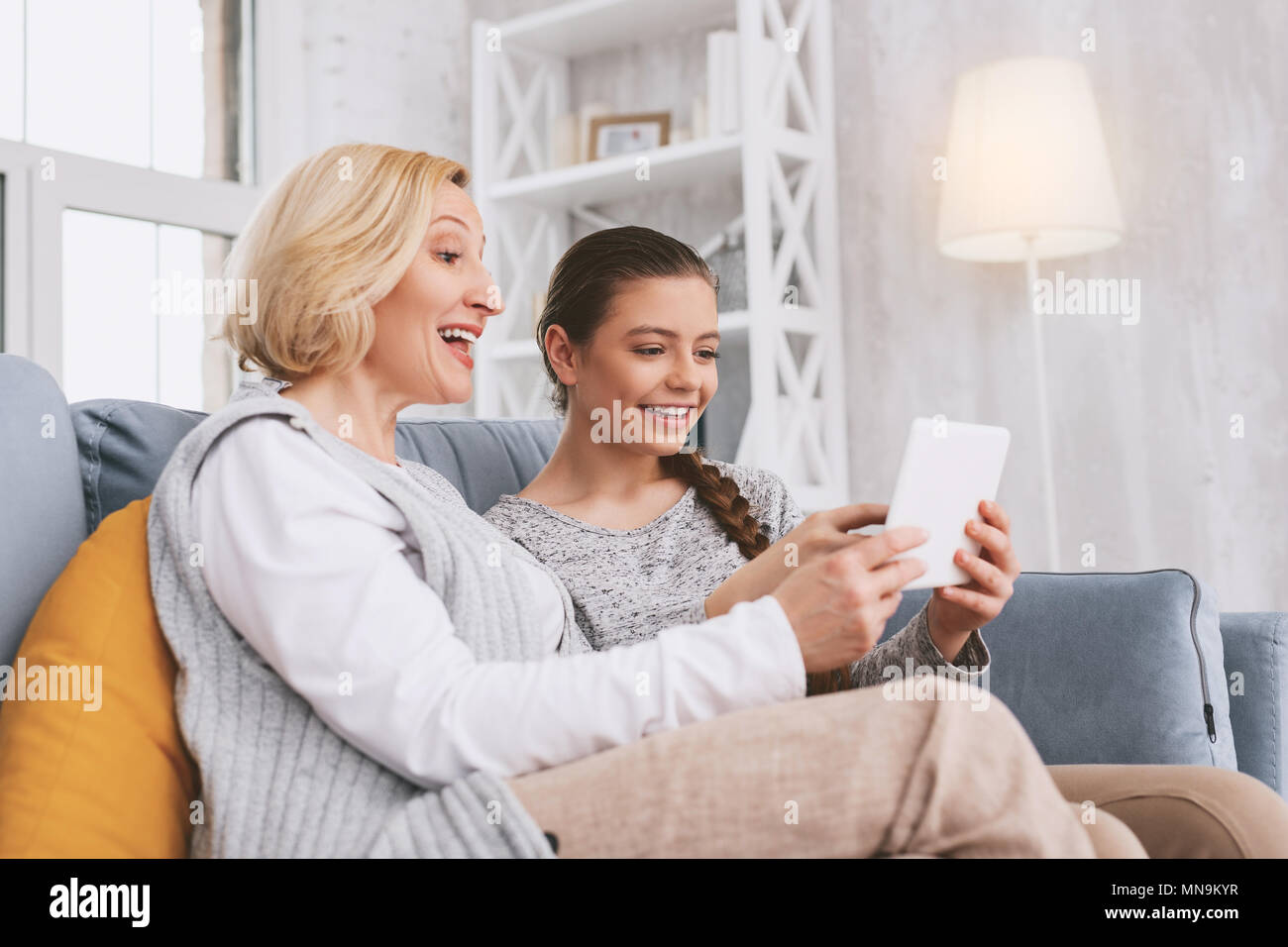Surprised blonde raising her eyebrows Stock Photo - Alamy
