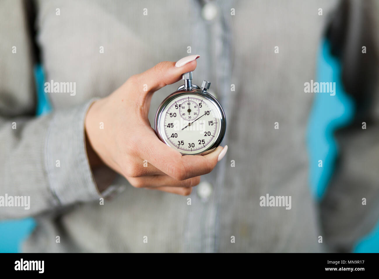 Female hand holding a retro stopwatch Stock Photo - Alamy