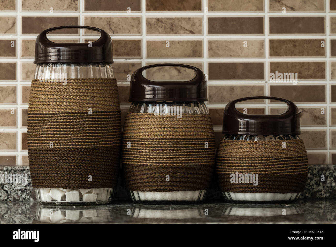 Rope wrapped decorative glass jars on brown background Stock Photo - Alamy