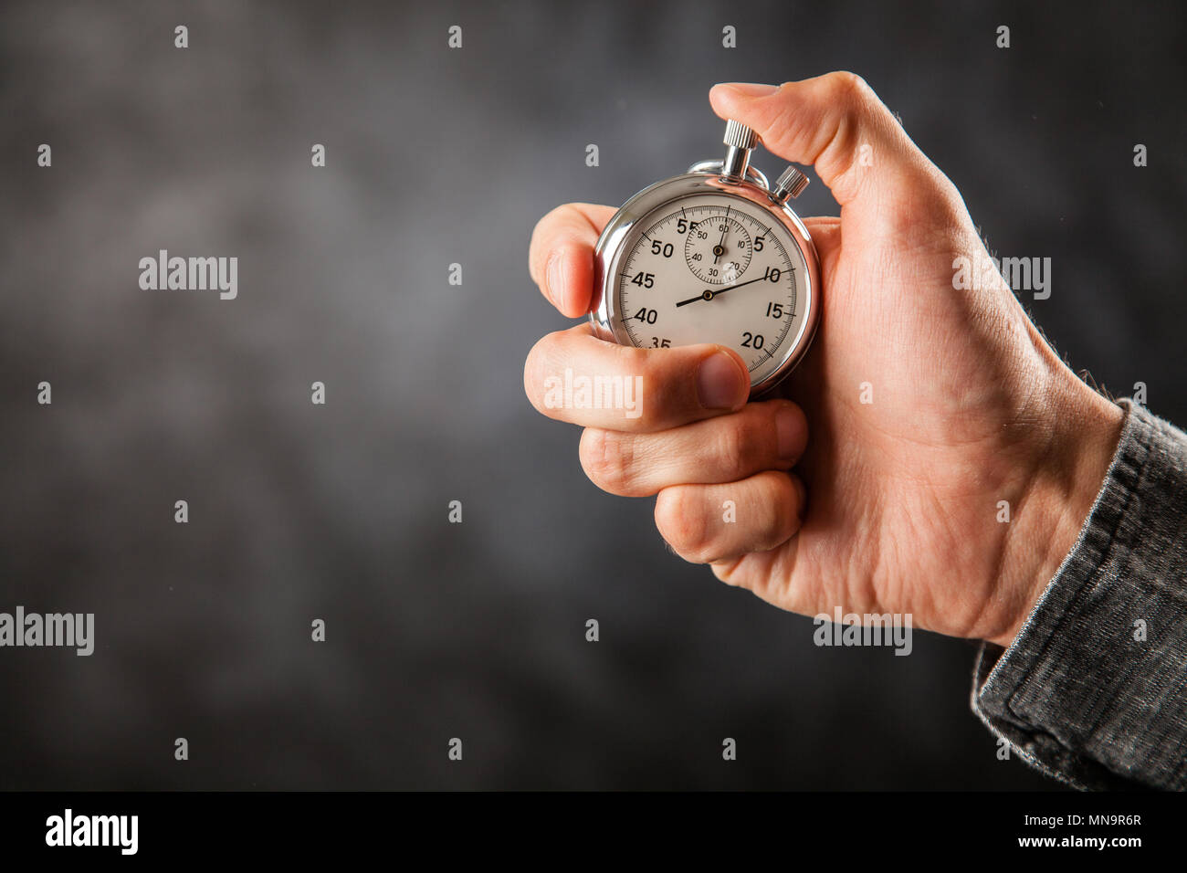 Analog stopwatch closeup on black background Stock Photo - Alamy
