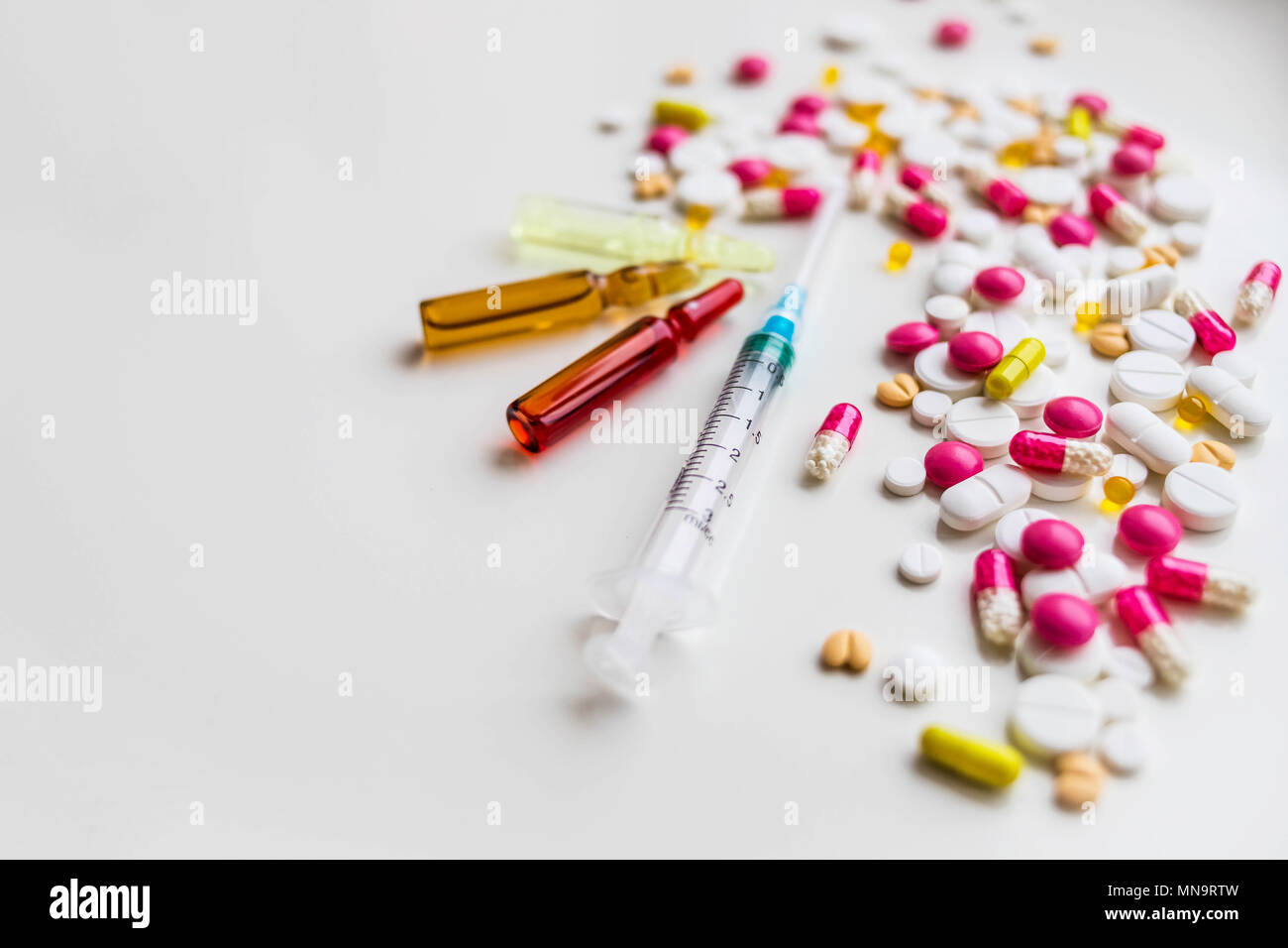 Medical colorful vials for injection syringe and red heart on a white ...