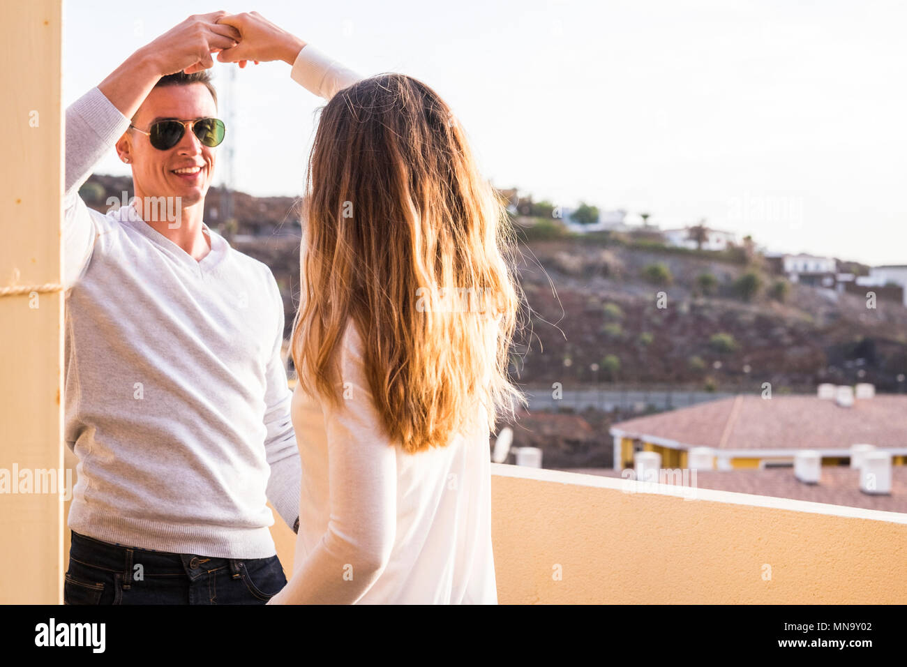 smile and happiness dancing outdoor on the terrace. couple in love and ...