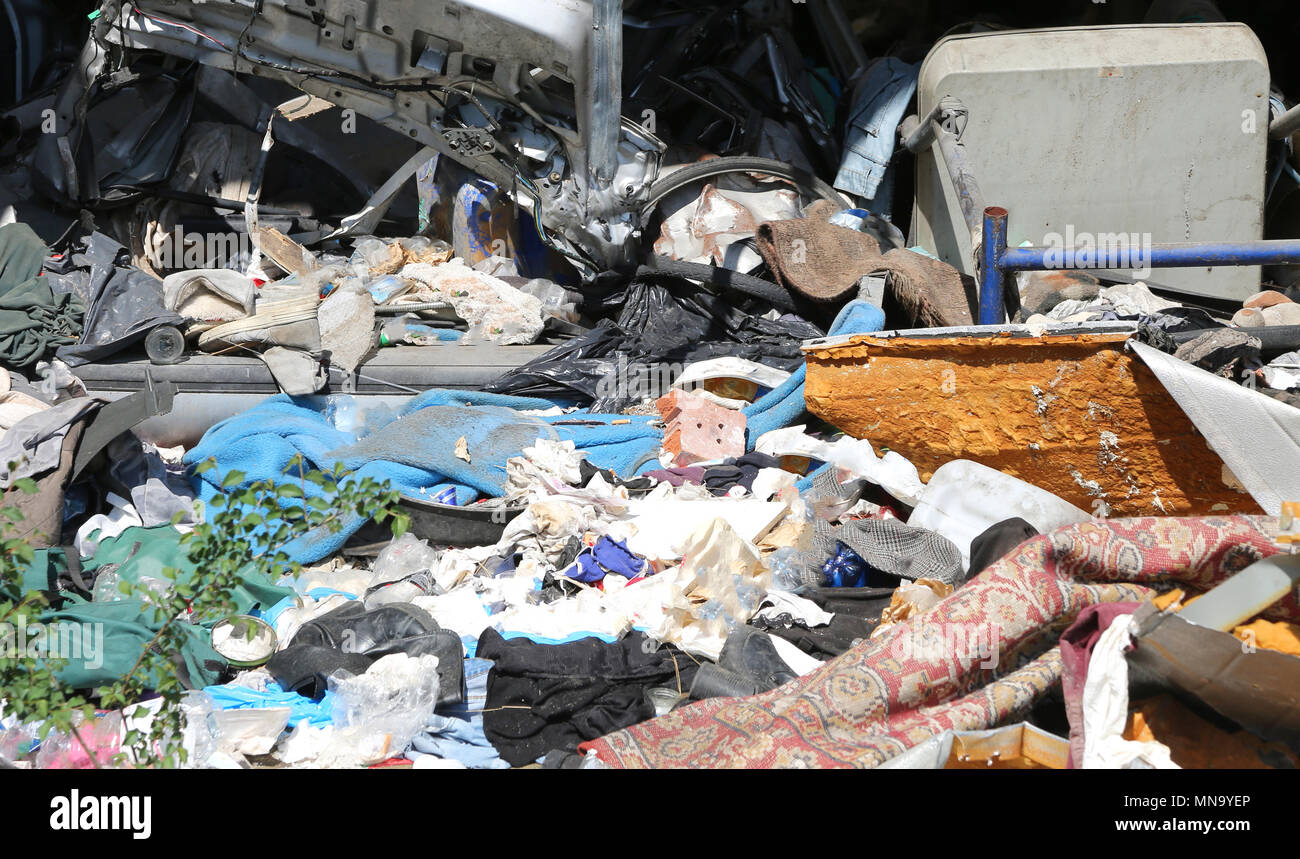 pile of rags and garbage in a homeless camp after the forced eviction ...