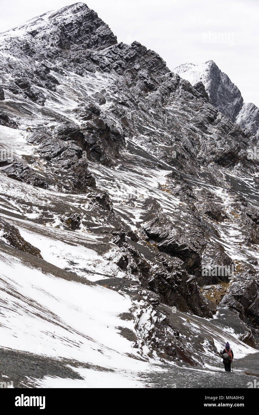 Woman hiking through the snow clad Andes Mountains in the Cordillera ...