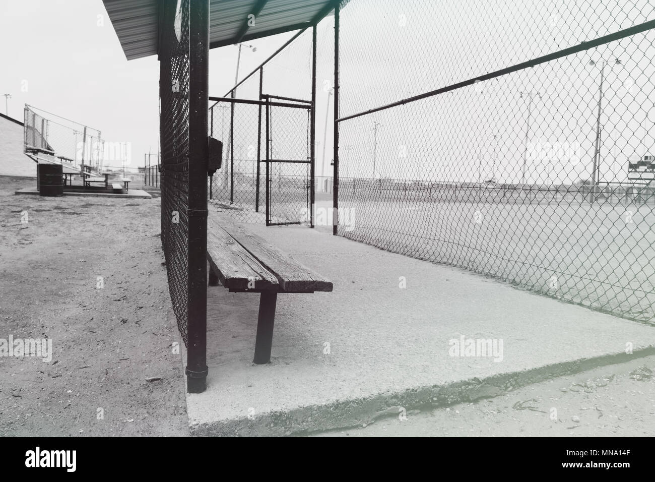 Empty Baseball stadium dugout with bench and fence. Black and white ...
