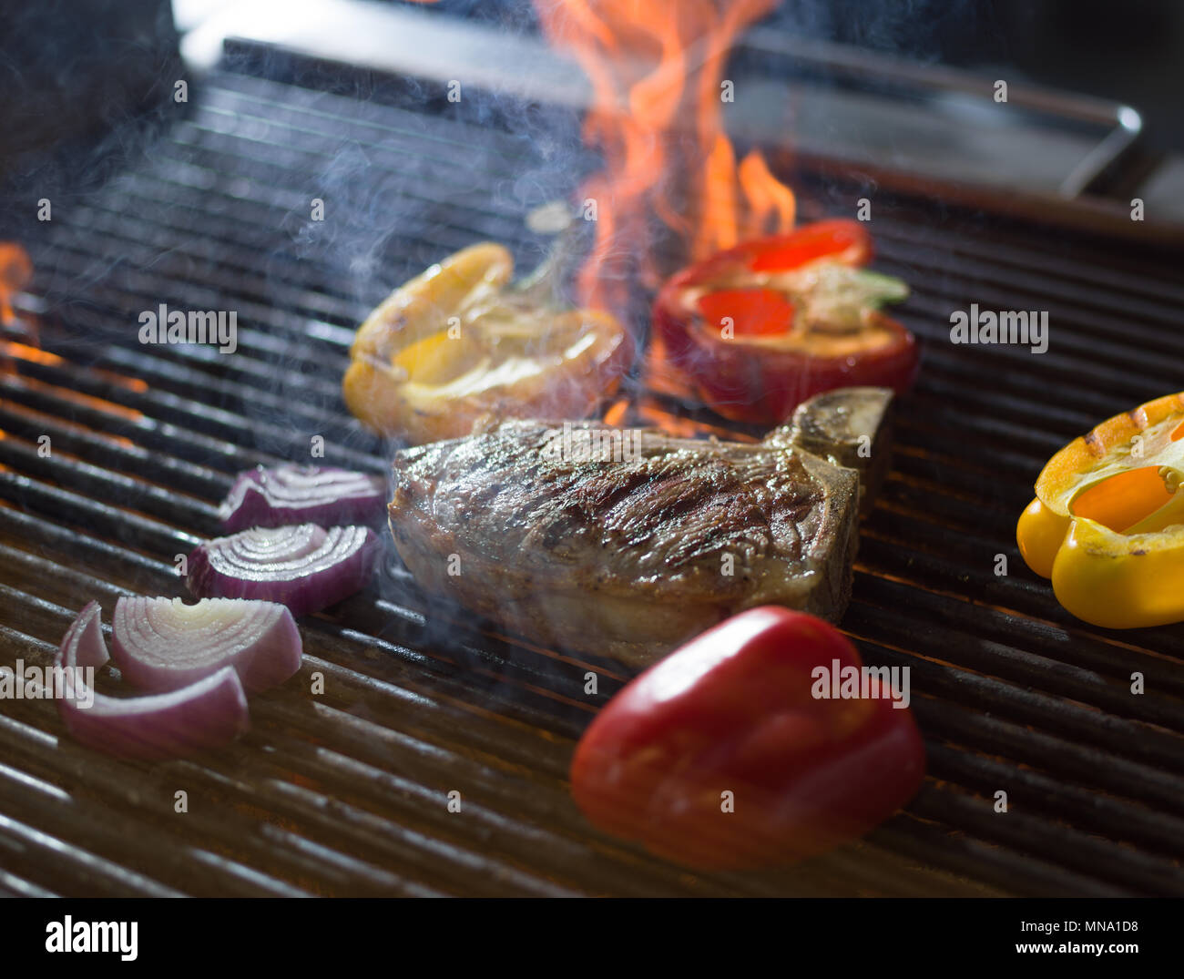 delicious grilled meat steak with vegetables on a barbecue Stock Photo ...