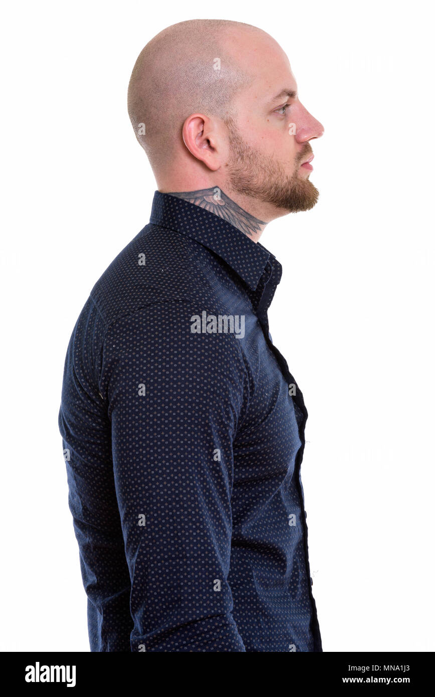 Studio shot of young bald muscular businessman Stock Photo - Alamy