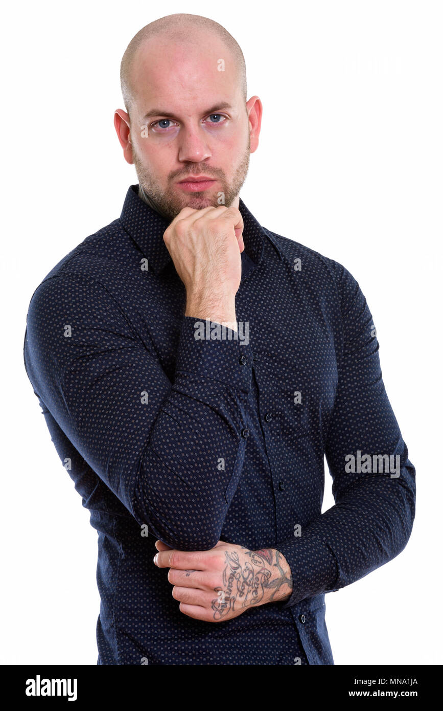Studio shot of young bald muscular businessman Stock Photo - Alamy