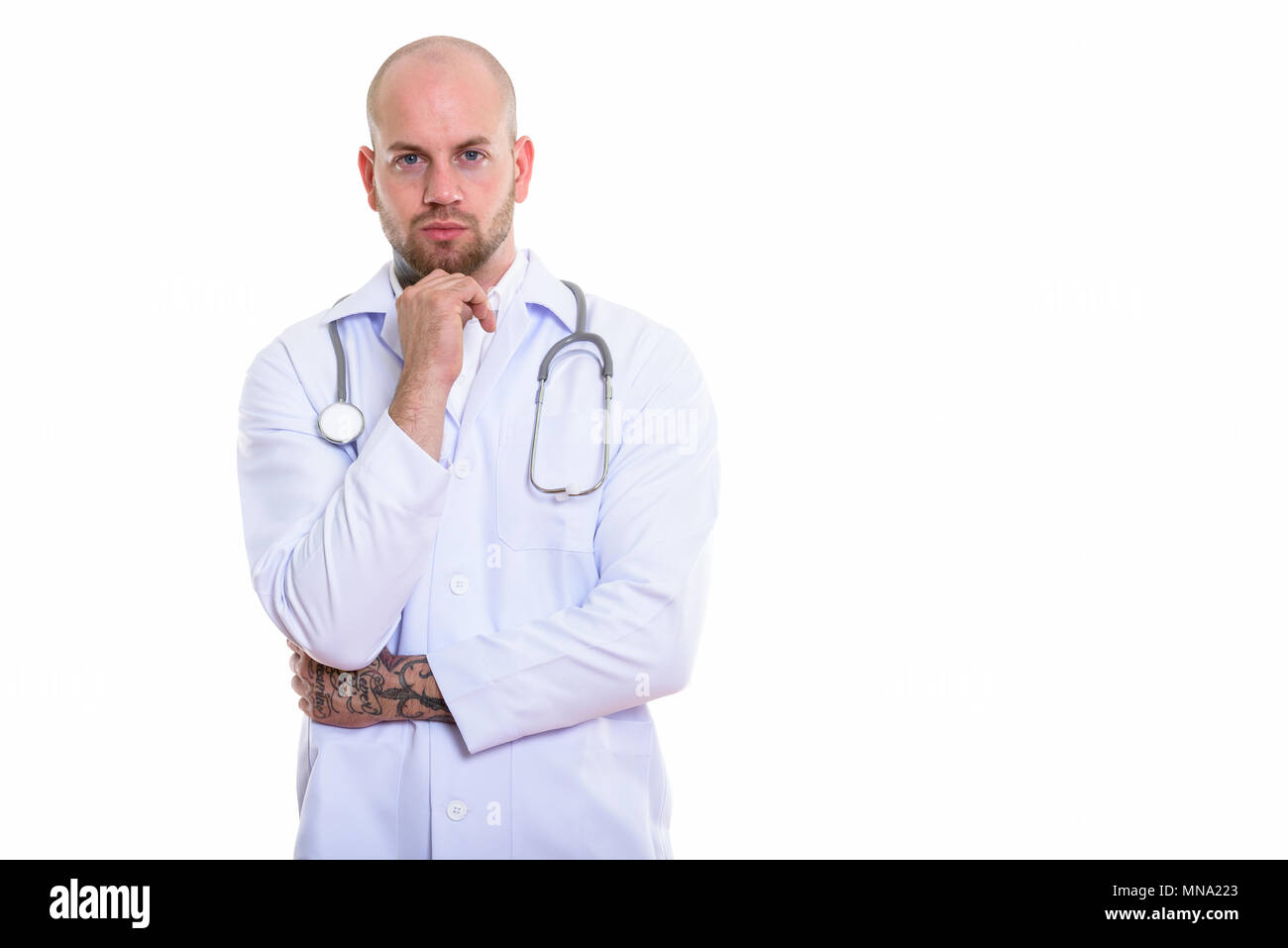 Studio shot of young bald muscular man doctor Stock Photo - Alamy