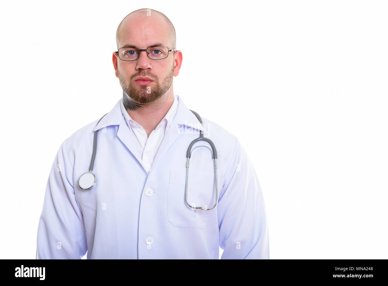 Studio shot of young bald muscular man doctor Stock Photo - Alamy