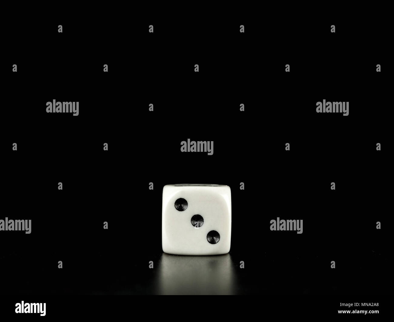 Game die isolated against black background, face with number three ...