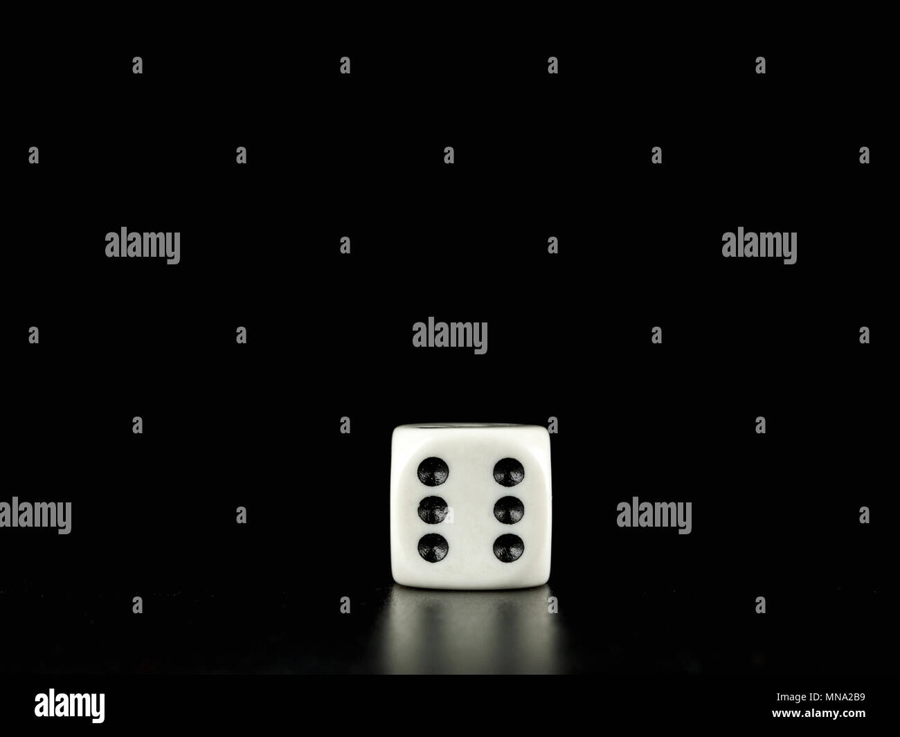 Game die isolated against black background, face with number six Stock ...