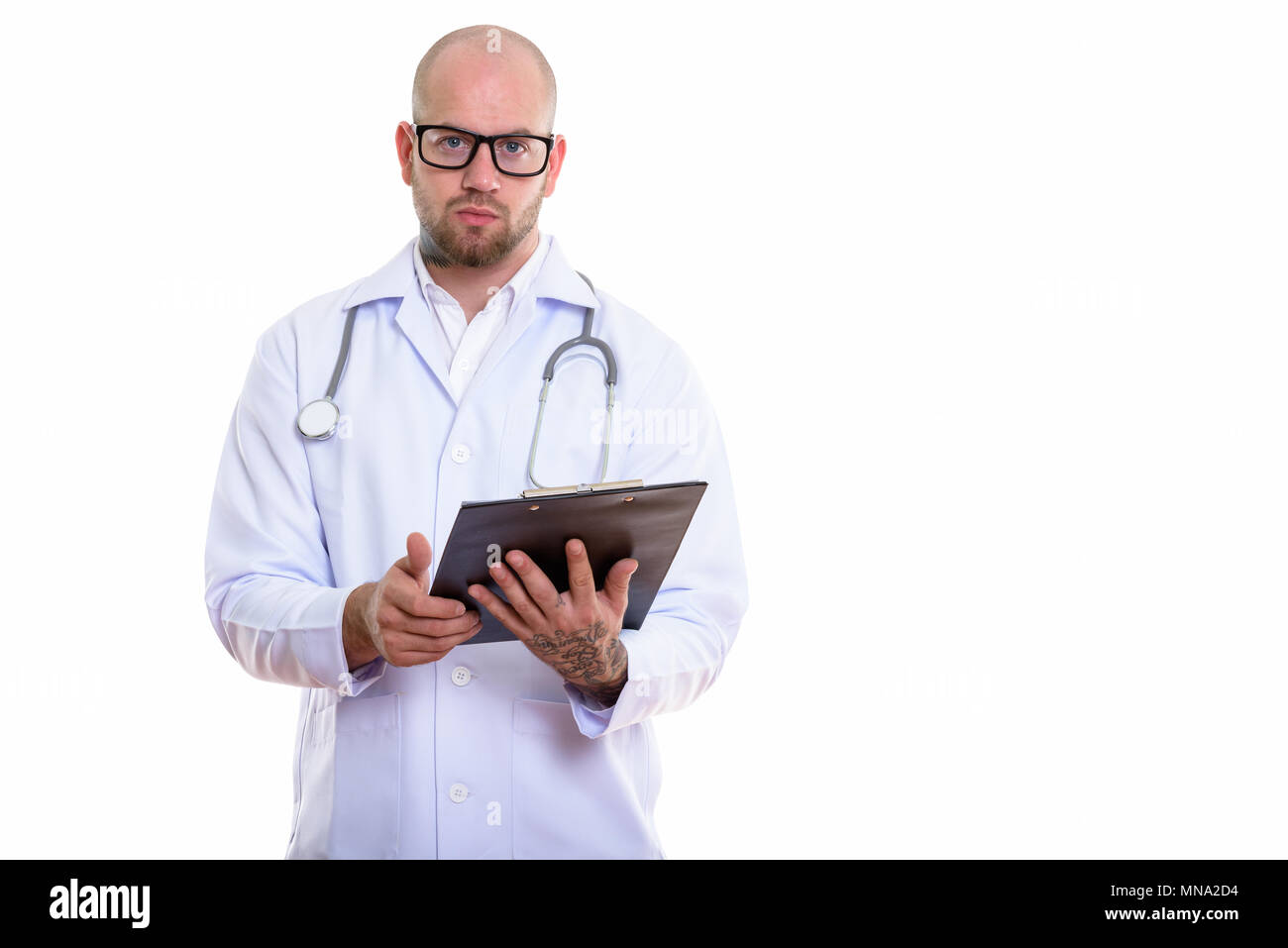 Studio shot of young bald muscular man doctor Stock Photo - Alamy