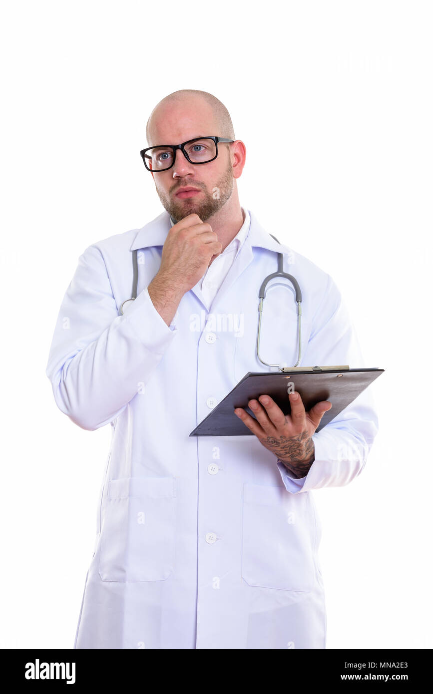 Studio shot of young bald muscular man doctor Stock Photo - Alamy