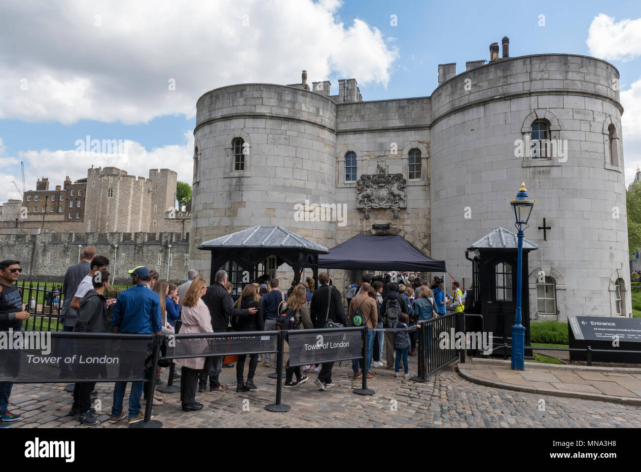 visitors and tourists queuing to enter the tower of london landmark ...