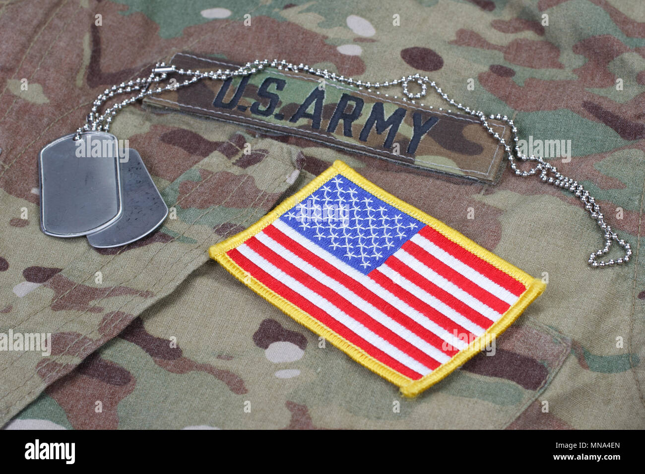 us army camouflaged uniform with US flag patch and blank dog tags Stock ...