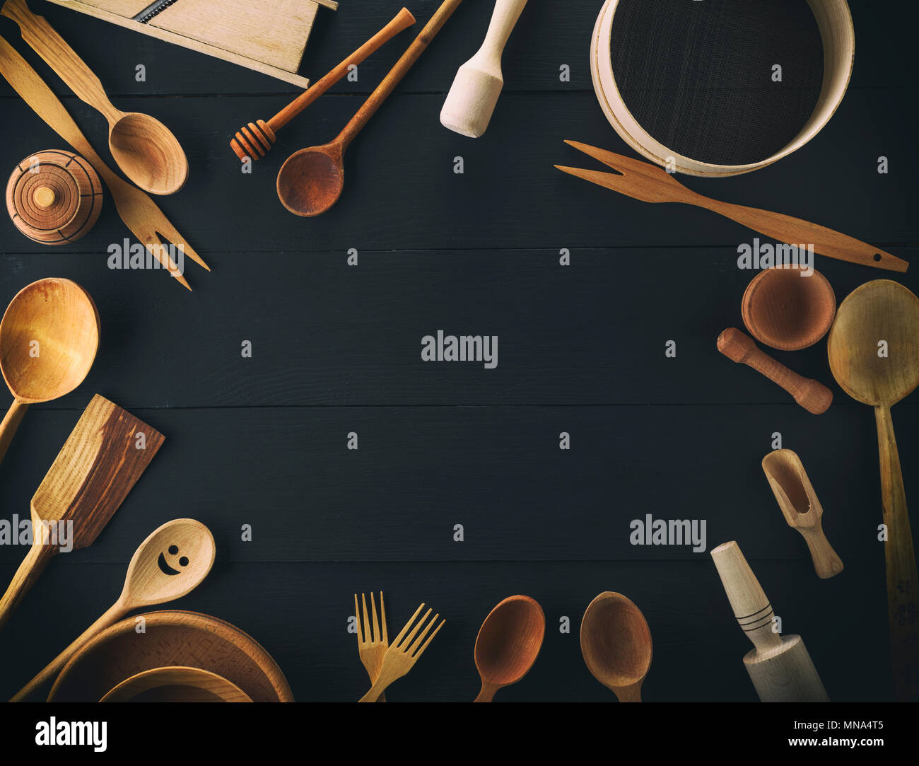 wooden round plates, sieve and rolling pin and other kitchen items on a ...