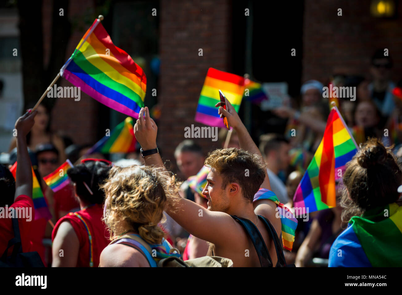 NEW YORK CITY - JUNE 25, 2017: Participants wave rainbow flags in the ...