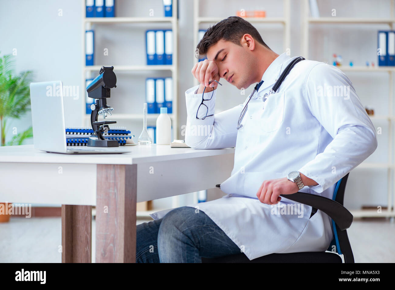 Tired doctor after night shift Stock Photo - Alamy